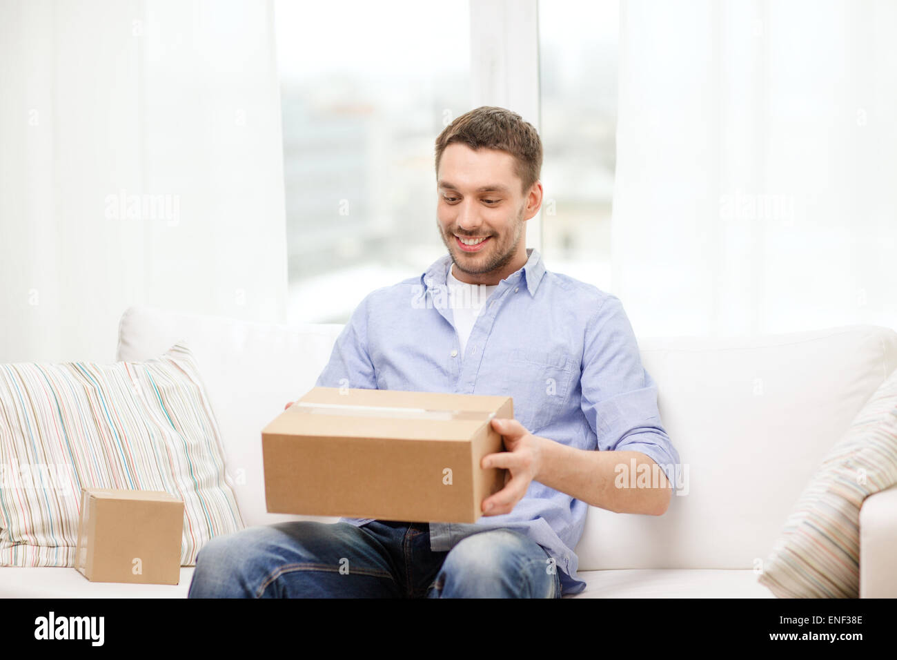 man with cardboard boxes at home Stock Photo - Alamy