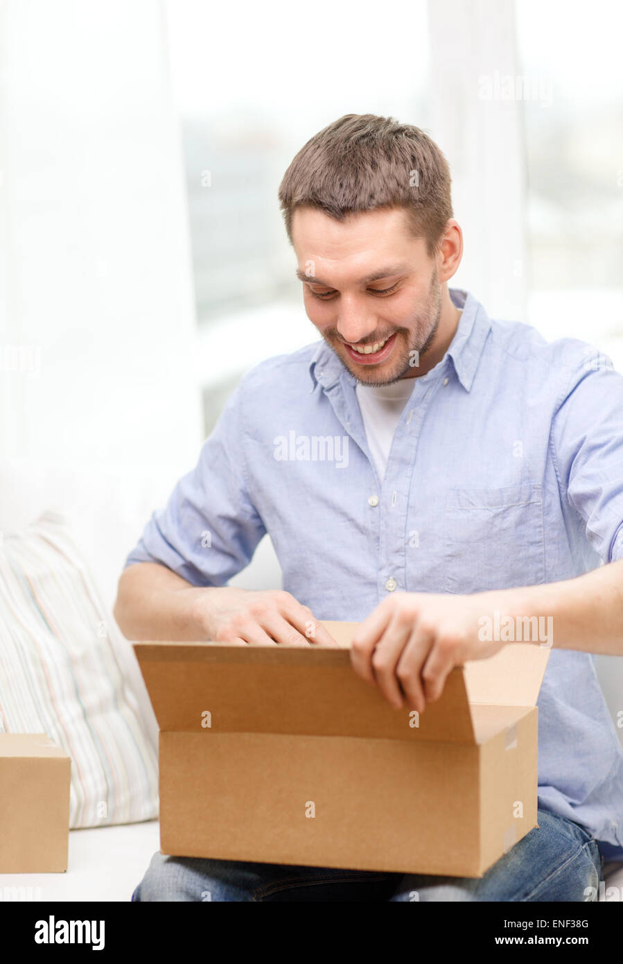 man with cardboard boxes at home Stock Photo - Alamy