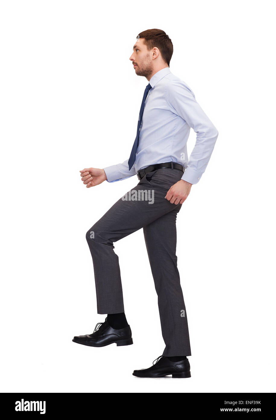 serious businessman stepping on imaginary step Stock Photo - Alamy