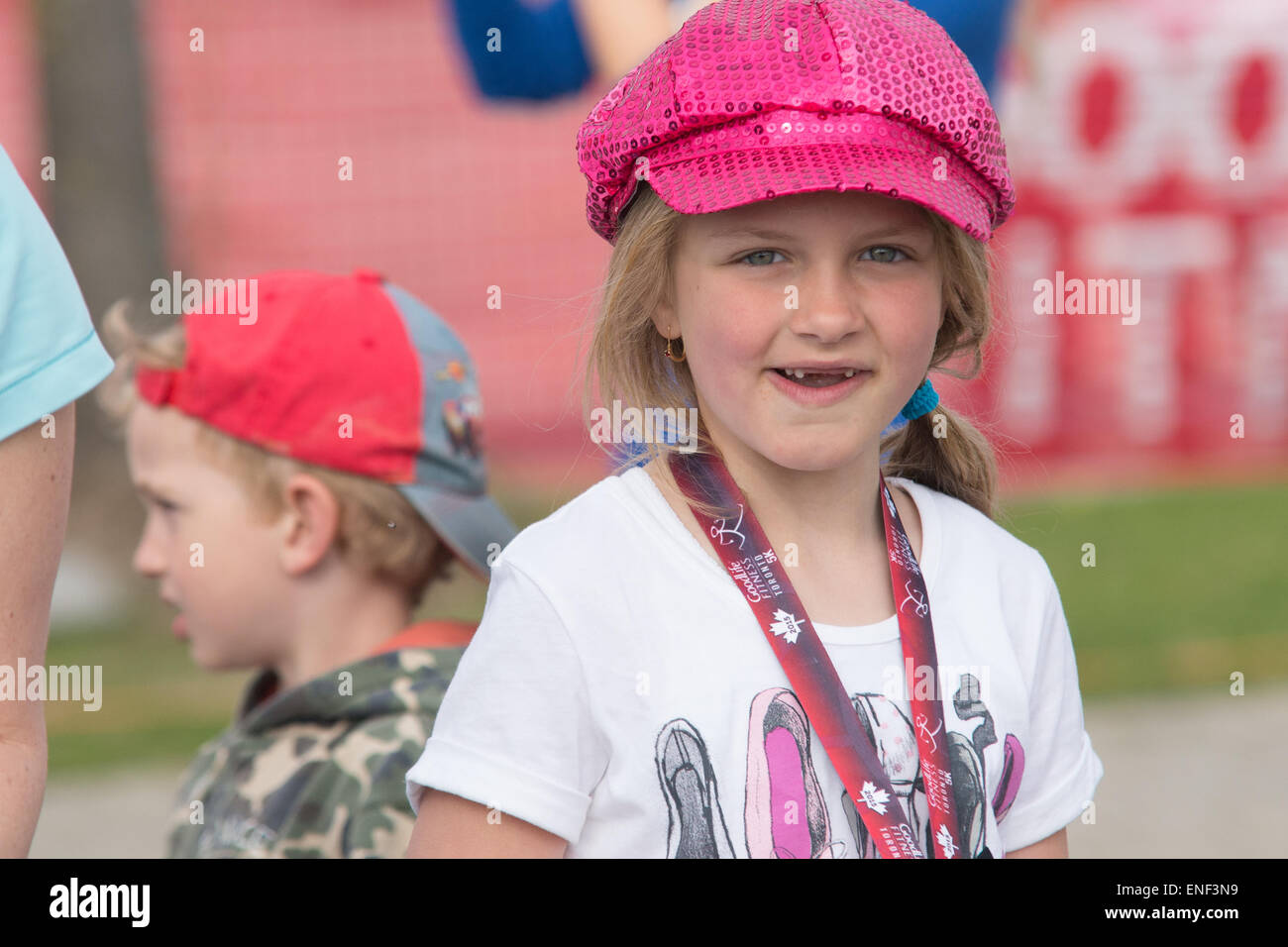 Toronto, Canada. 3rd May, 2015. Little runner girl showing off medal at ...