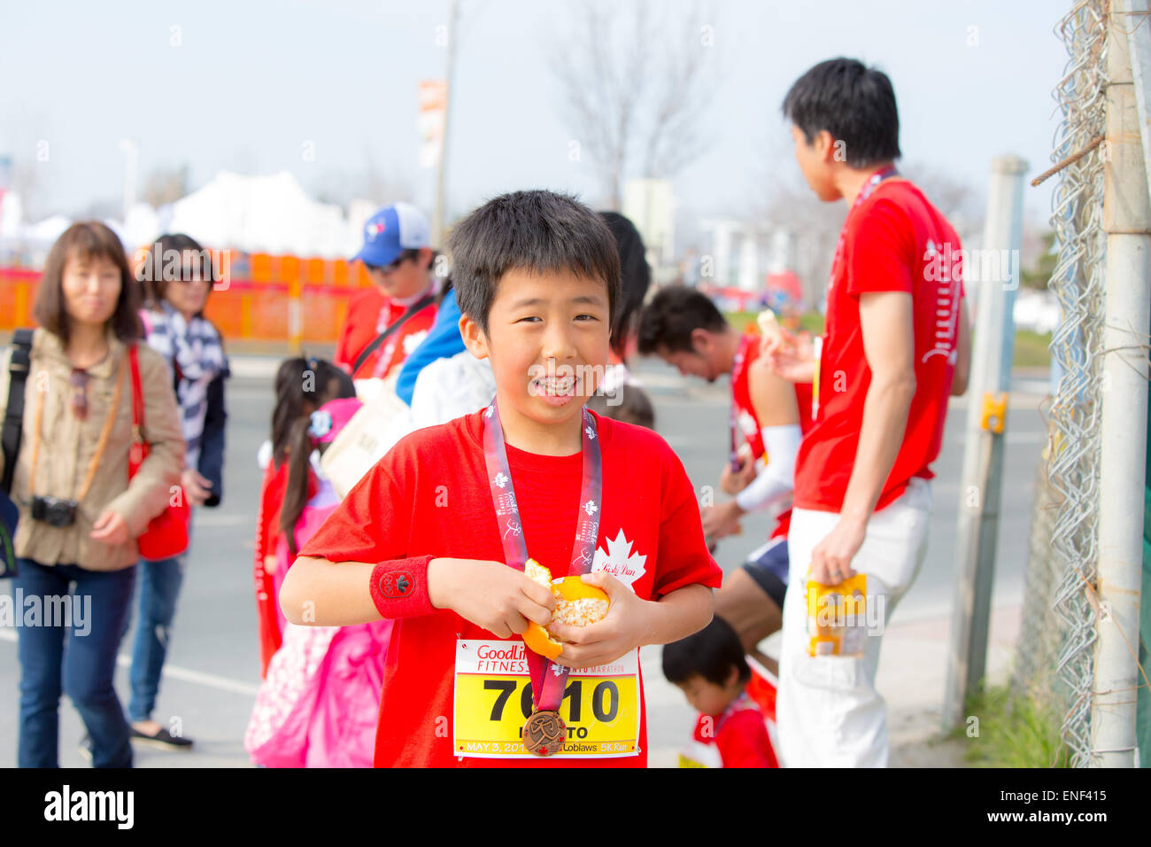 Toronto, Canada. 3rd May, 2015. Little boy having orange after running ...
