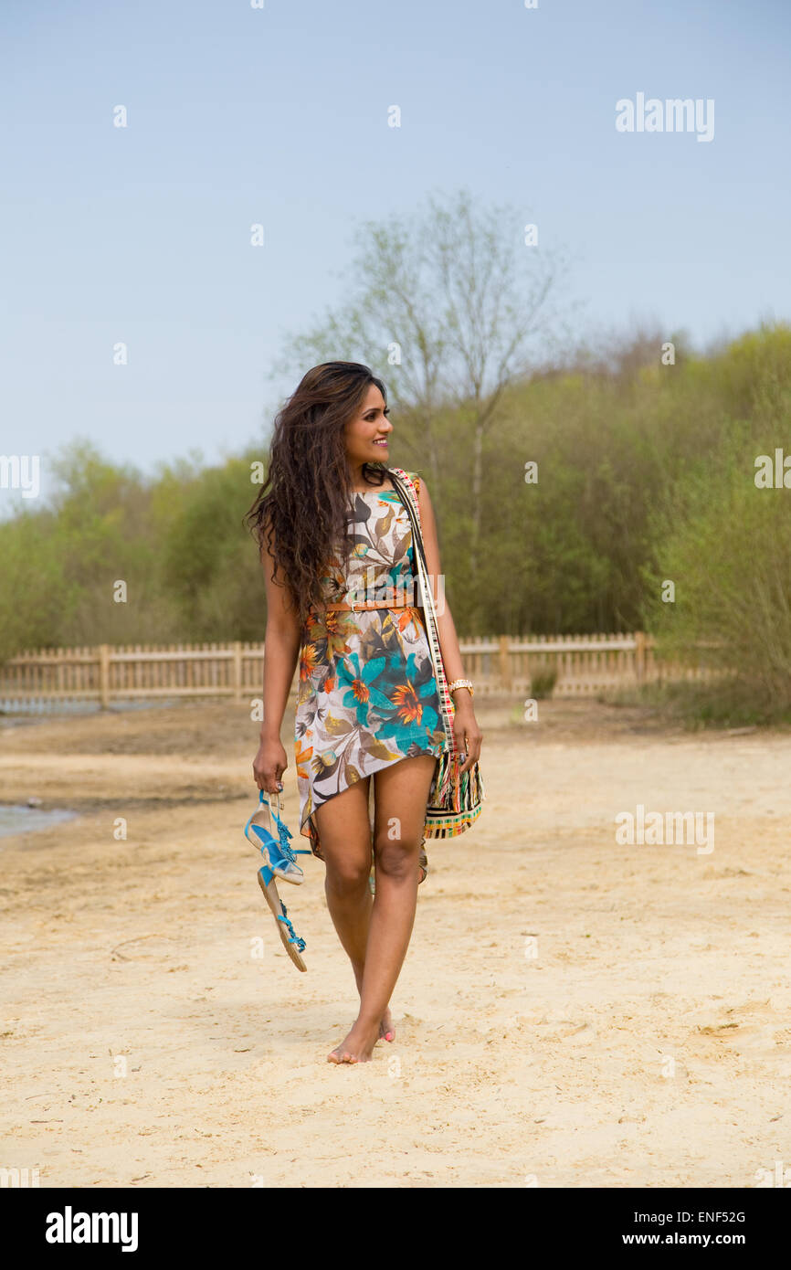 young indian woman walking along the river Stock Photo - Alamy