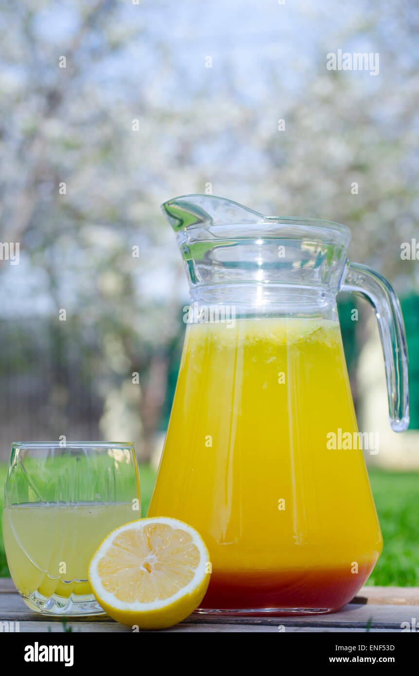 Yellow lemonade with red syrup and slice of lemon Stock Photo - Alamy