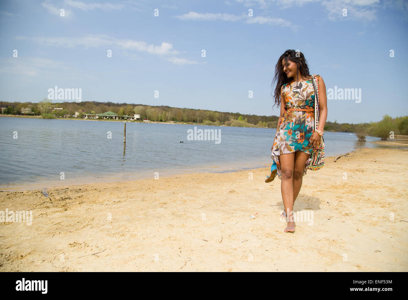 young woman walking along the bank of a lake Stock Photo - Alamy