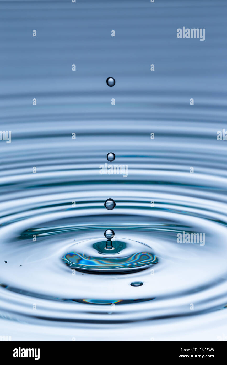 Drop of water falling into water surface, macro photo Stock Photo - Alamy