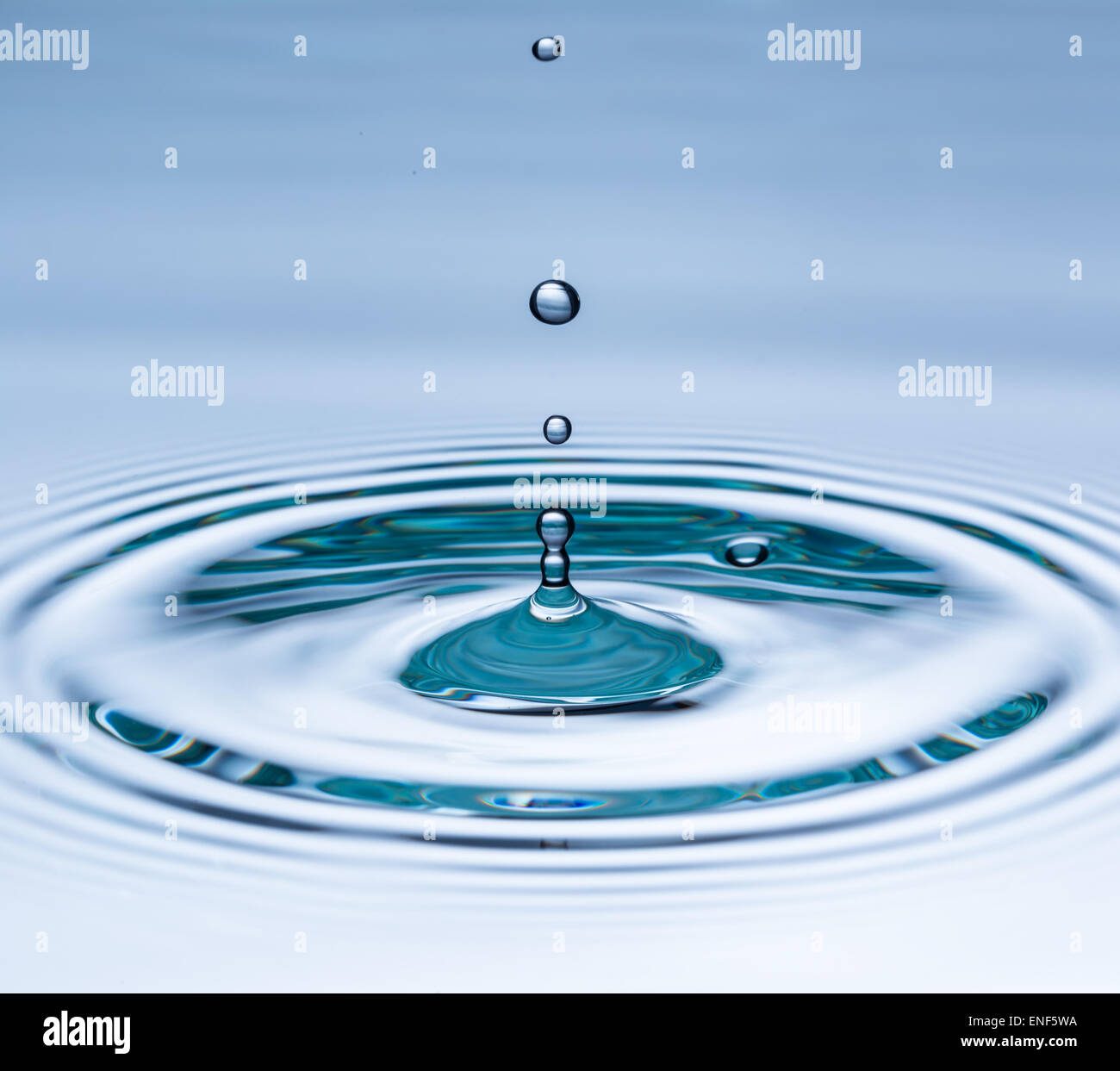 Drop of water falling into water surface, macro photo Stock Photo - Alamy