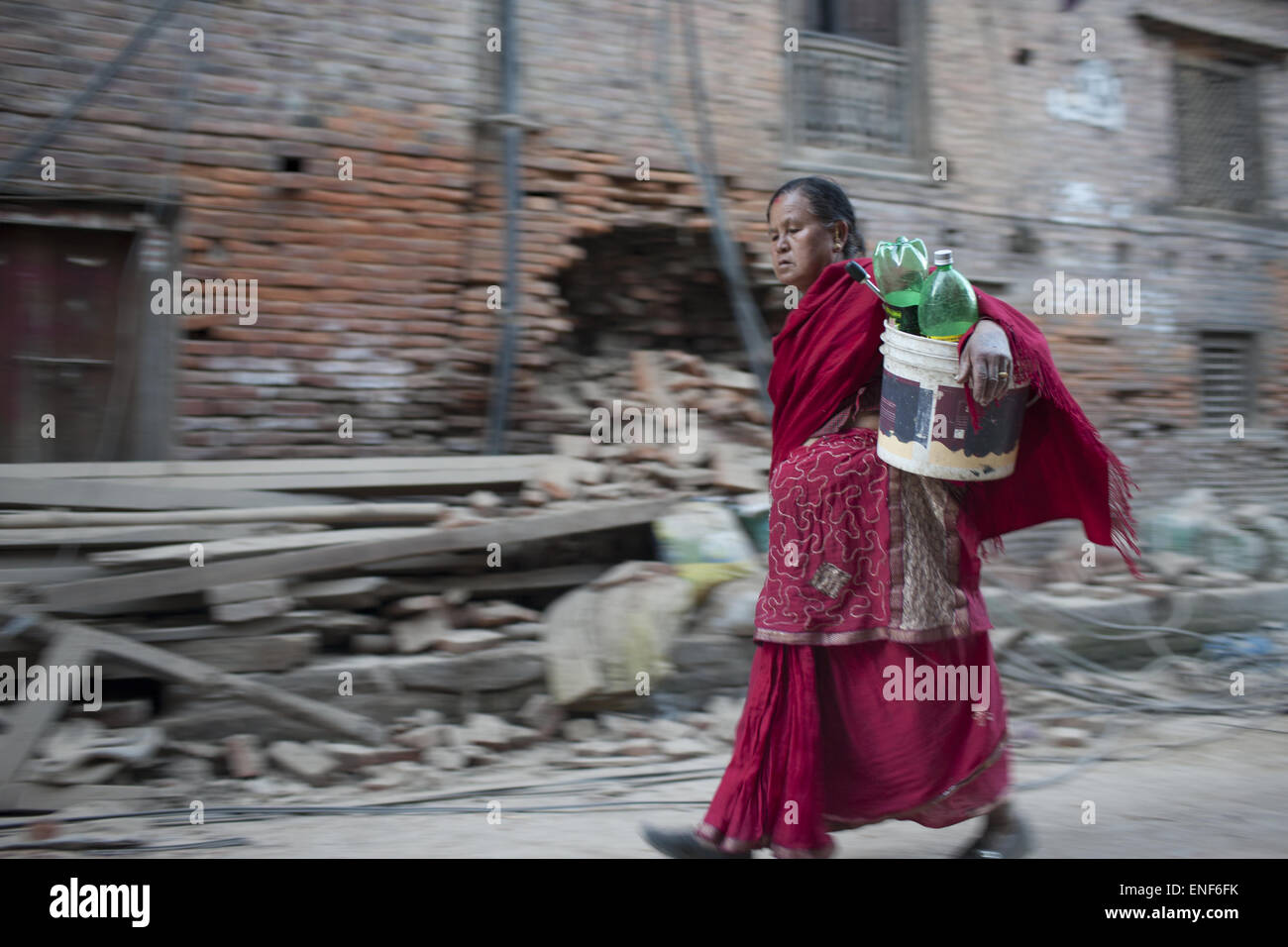 Kathmandu, Nepal. 4th May, 2015. A woman runs to collect drinking water ...