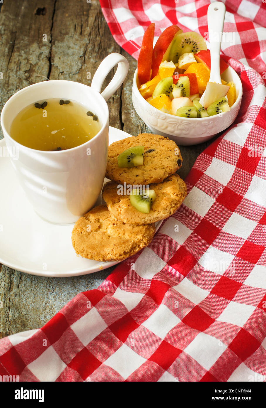 Cup of tea and bowl with fruit salad Stock Photo - Alamy
