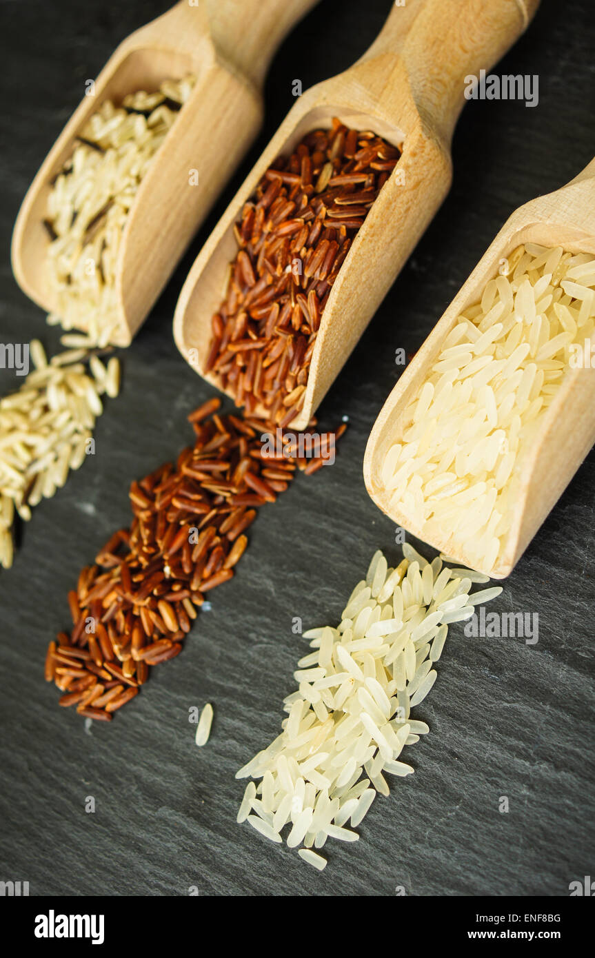 Different kinds of rice in the pots on the rustic table Stock Photo - Alamy
