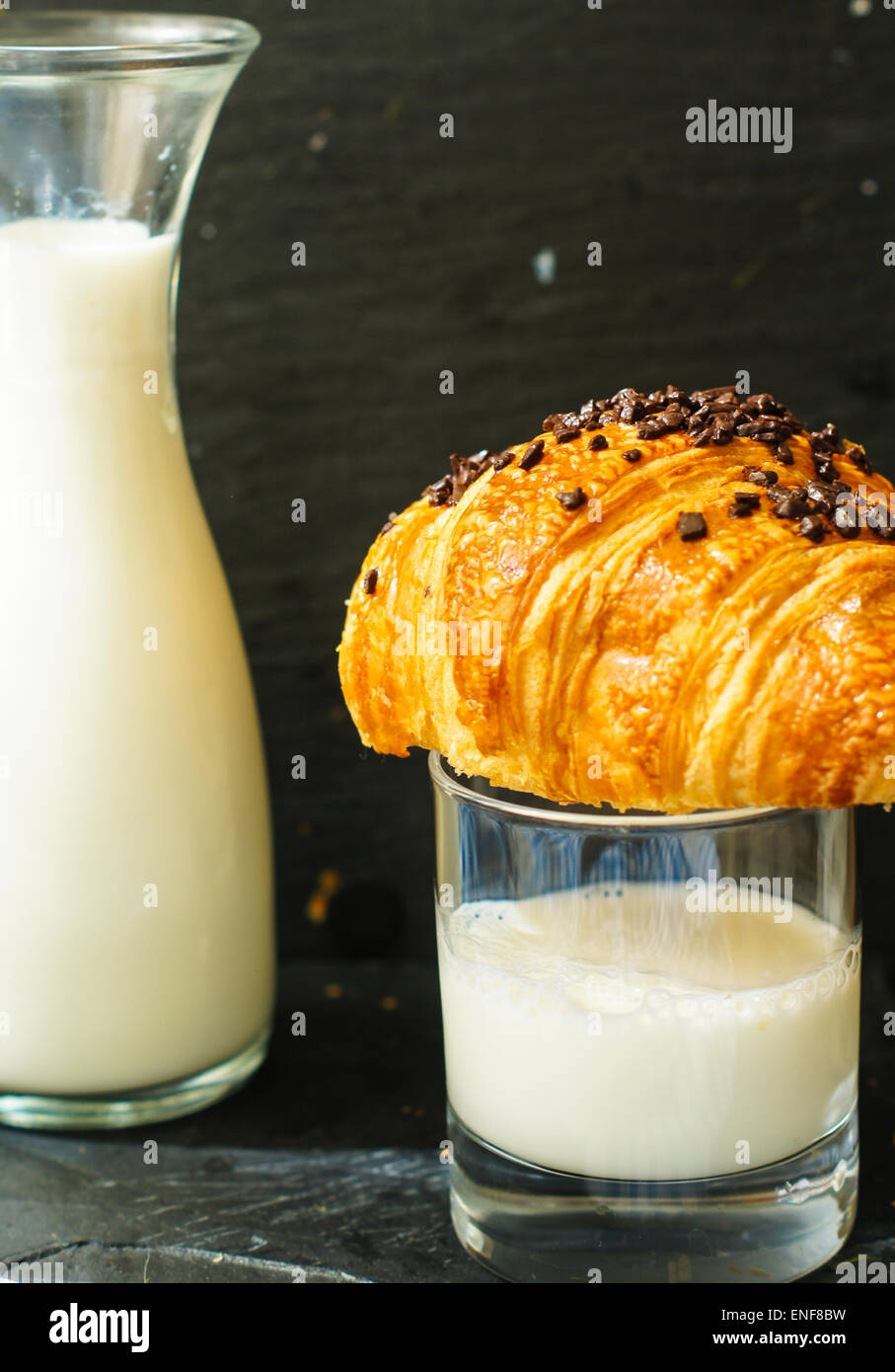 Breakfast time, fresh croissant with chocolate and milk Stock Photo - Alamy