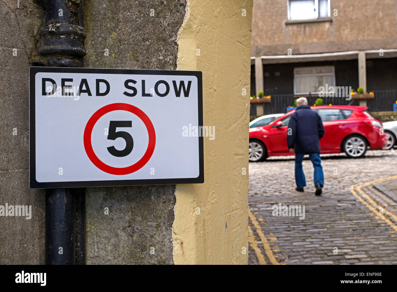 Dead Slow sign on a narrow road leading onto the main street in South ...
