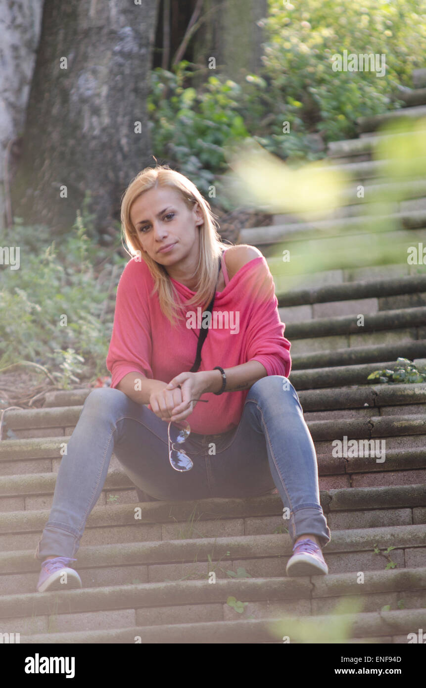 Woman sitting on stairs hi-res stock photography and images - Alamy