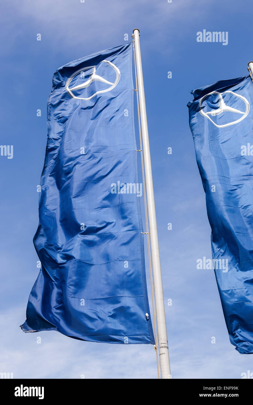 The flags of Mercedes-Benz over blue sky. Mercedes-Benz is a German ...