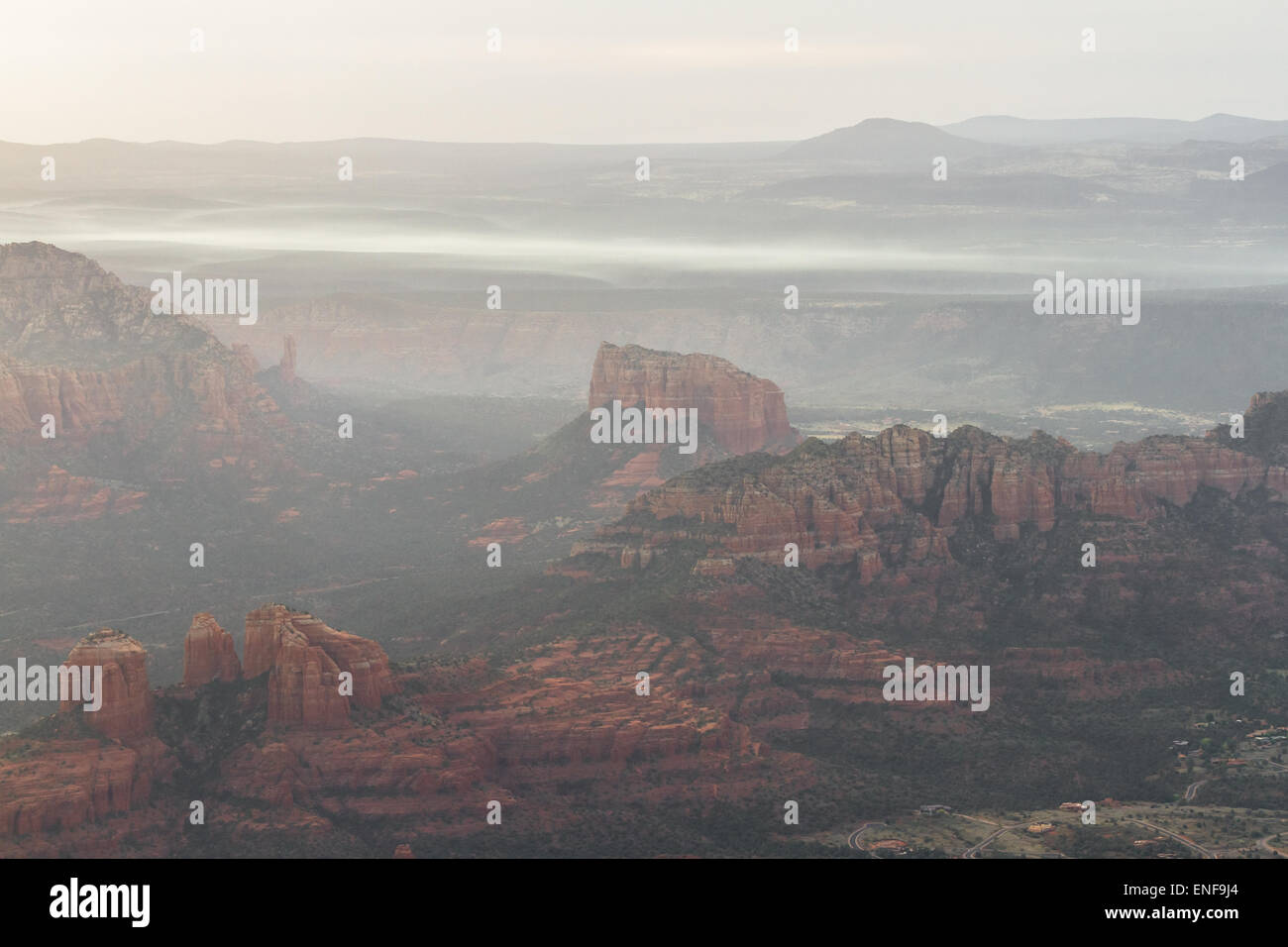 Aerial view of the red rock landscape of Sedona Arizona with smoke from ...