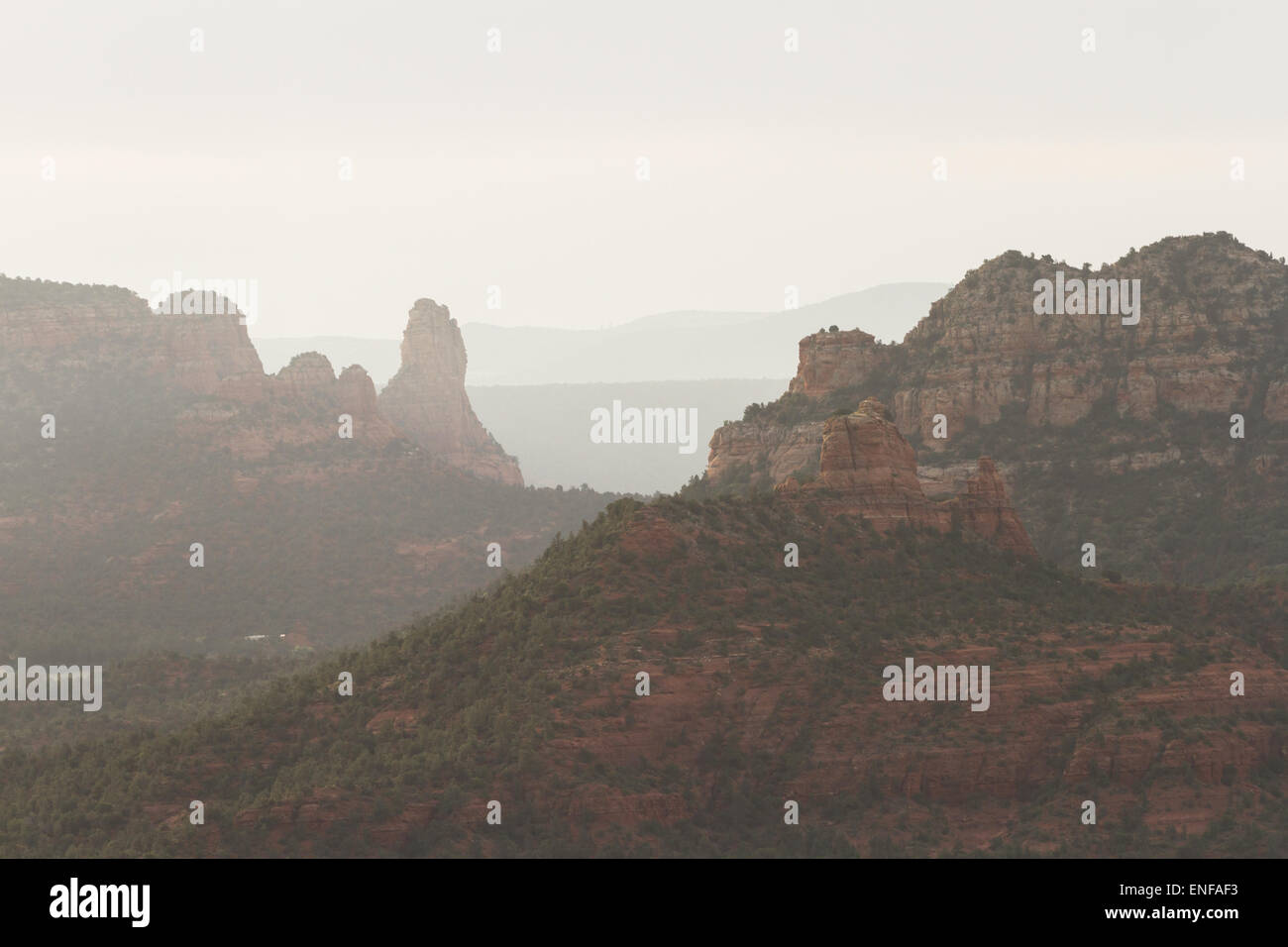 Aerial view of the red rock landscape of Sedona Arizona with smoke from ...