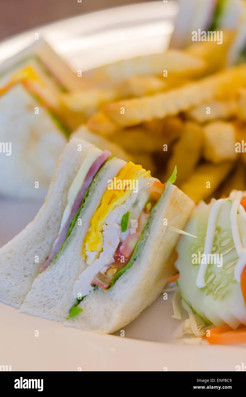Delicious club sandwich with french fries at a dinner Stock Photo - Alamy