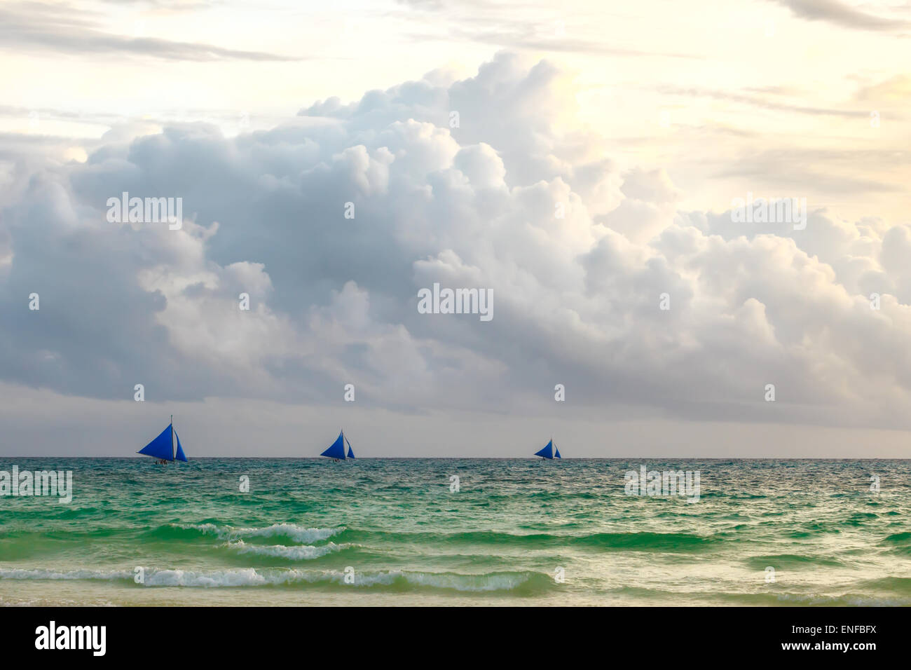 Three blue sailing boats on horizon of blue tropical sea, Philippines ...