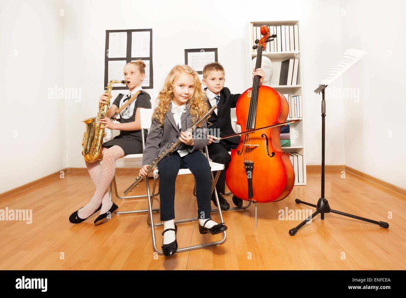 Happy kids playing musical instruments together Stock Photo - Alamy