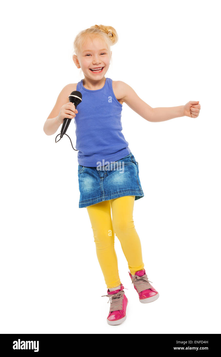 Cute small girl singing in microphone and dancing Stock Photo - Alamy