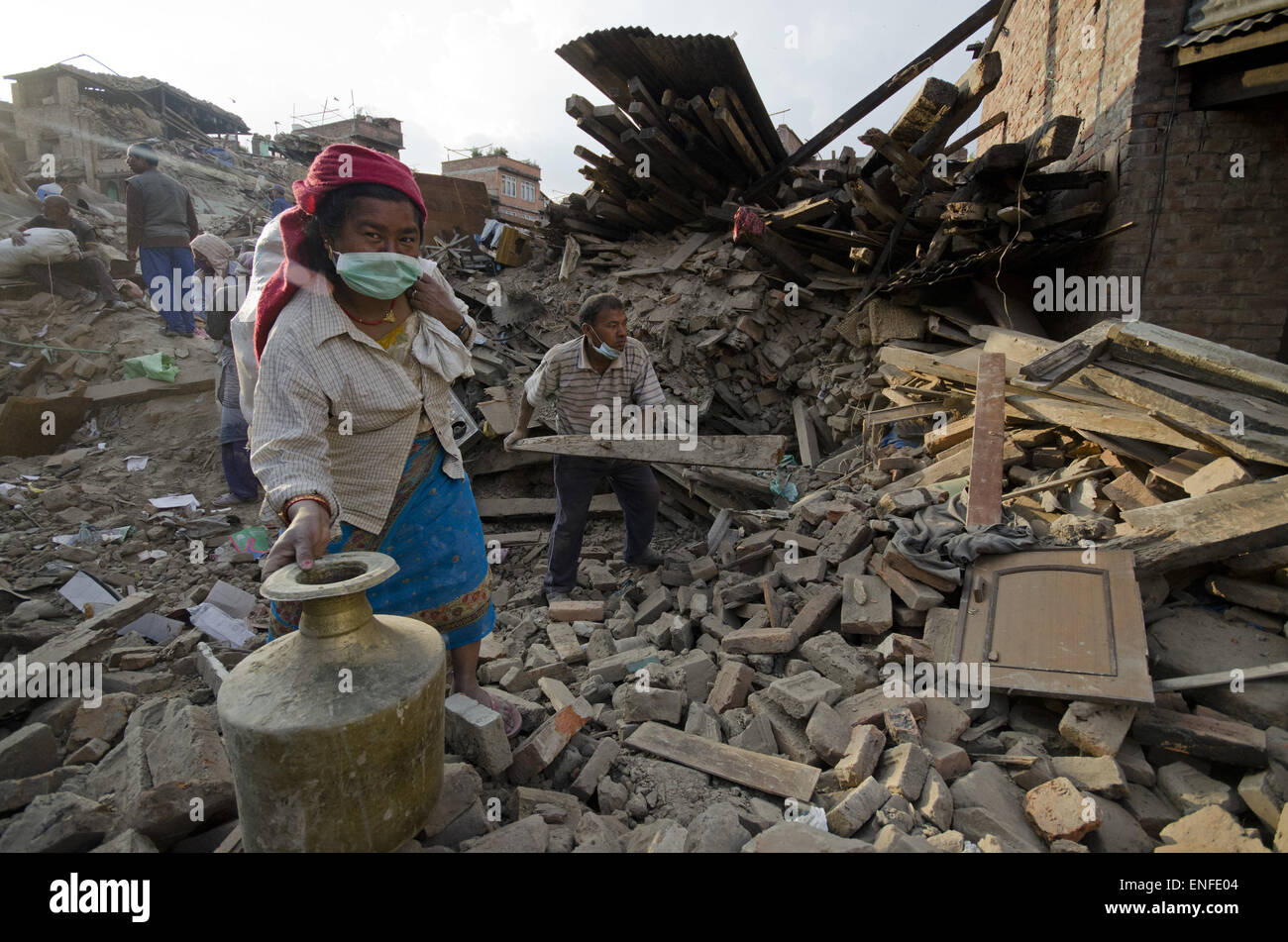 Bhaktapur, Nepal. 25th Apr, 2015. A woman recovers her Ã”Gagri', a ...