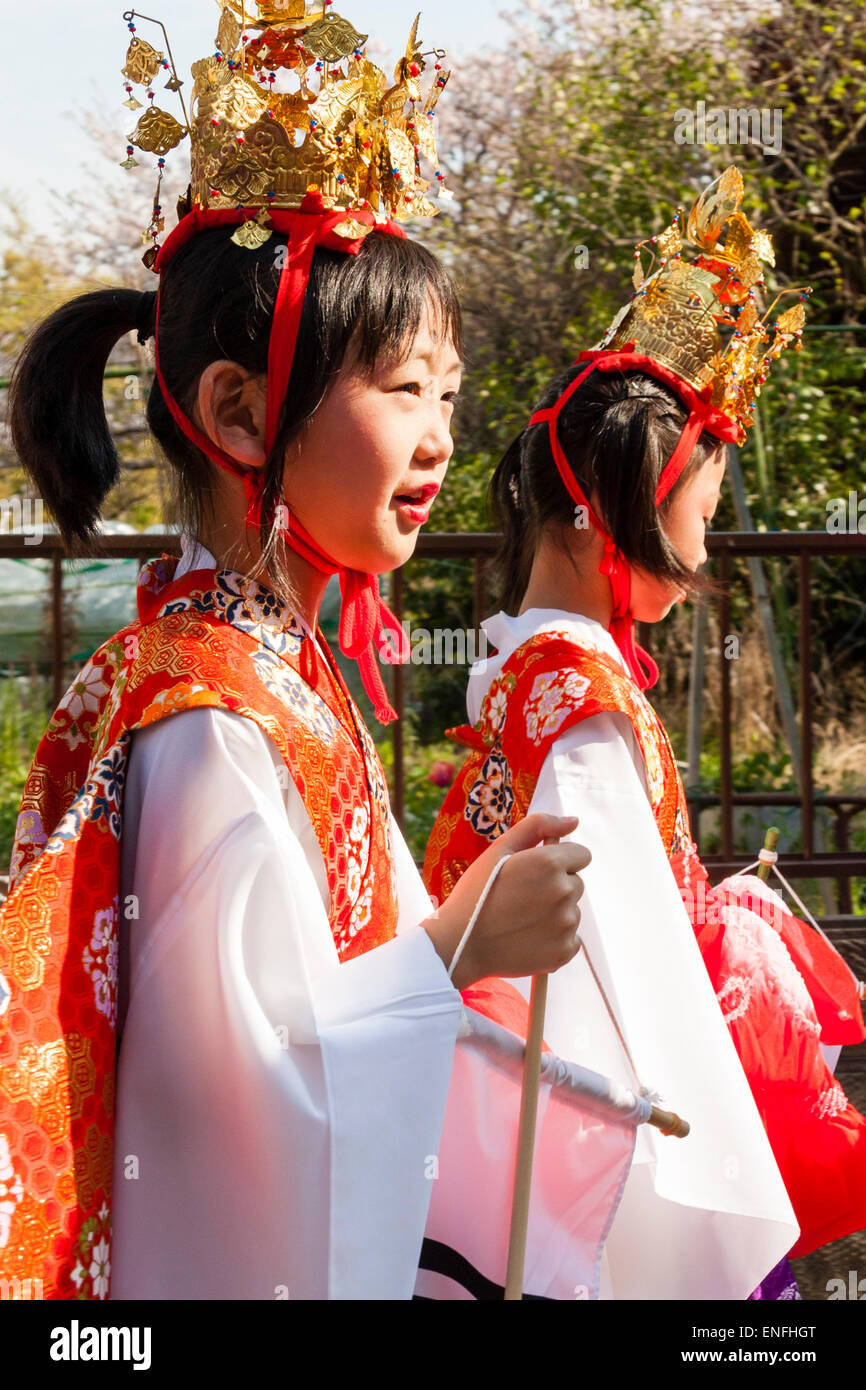 Side view, 2 Japanese children, girls, wearing red jacket with white ...