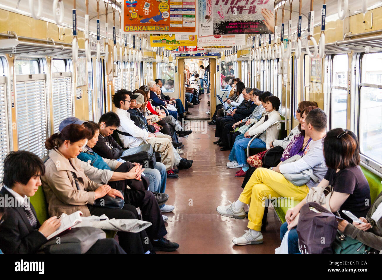 View along the Interior of of a crowded commuter railway carriage on ...