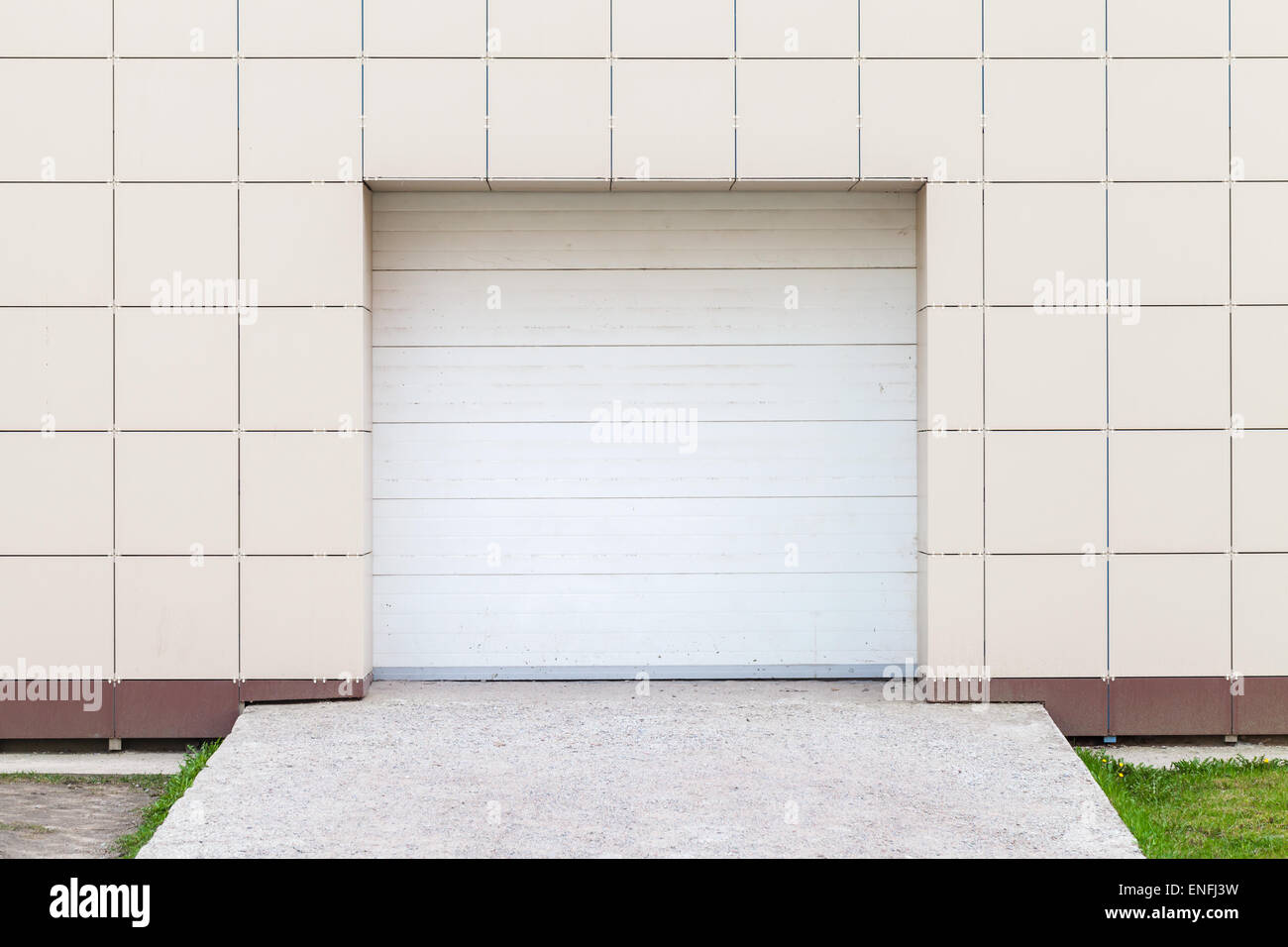 Modern storage building wall with closed white gate, photo background ...