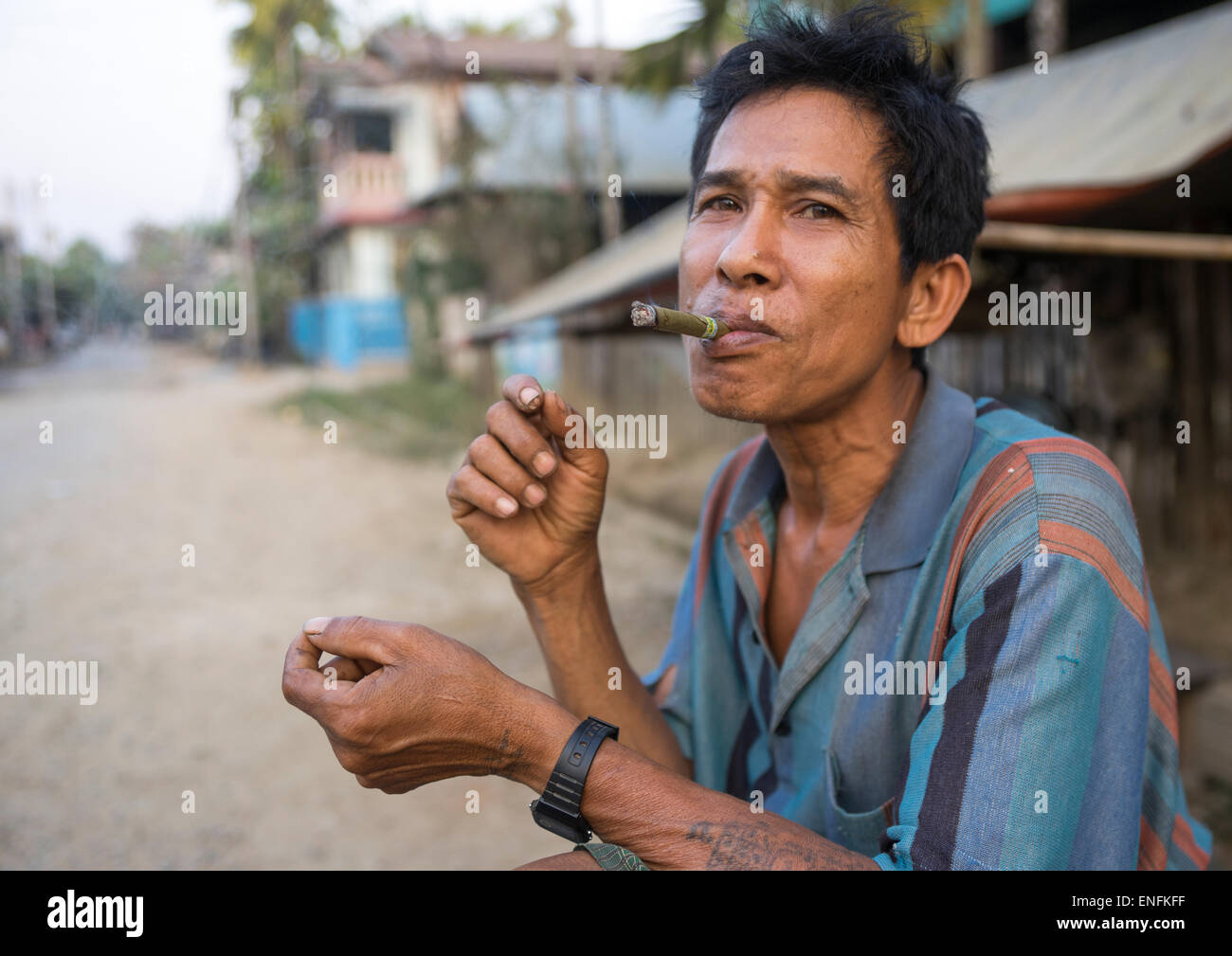 Man Smoking A Cigar, Thandwe, Myanmar Stock Photo - Alamy