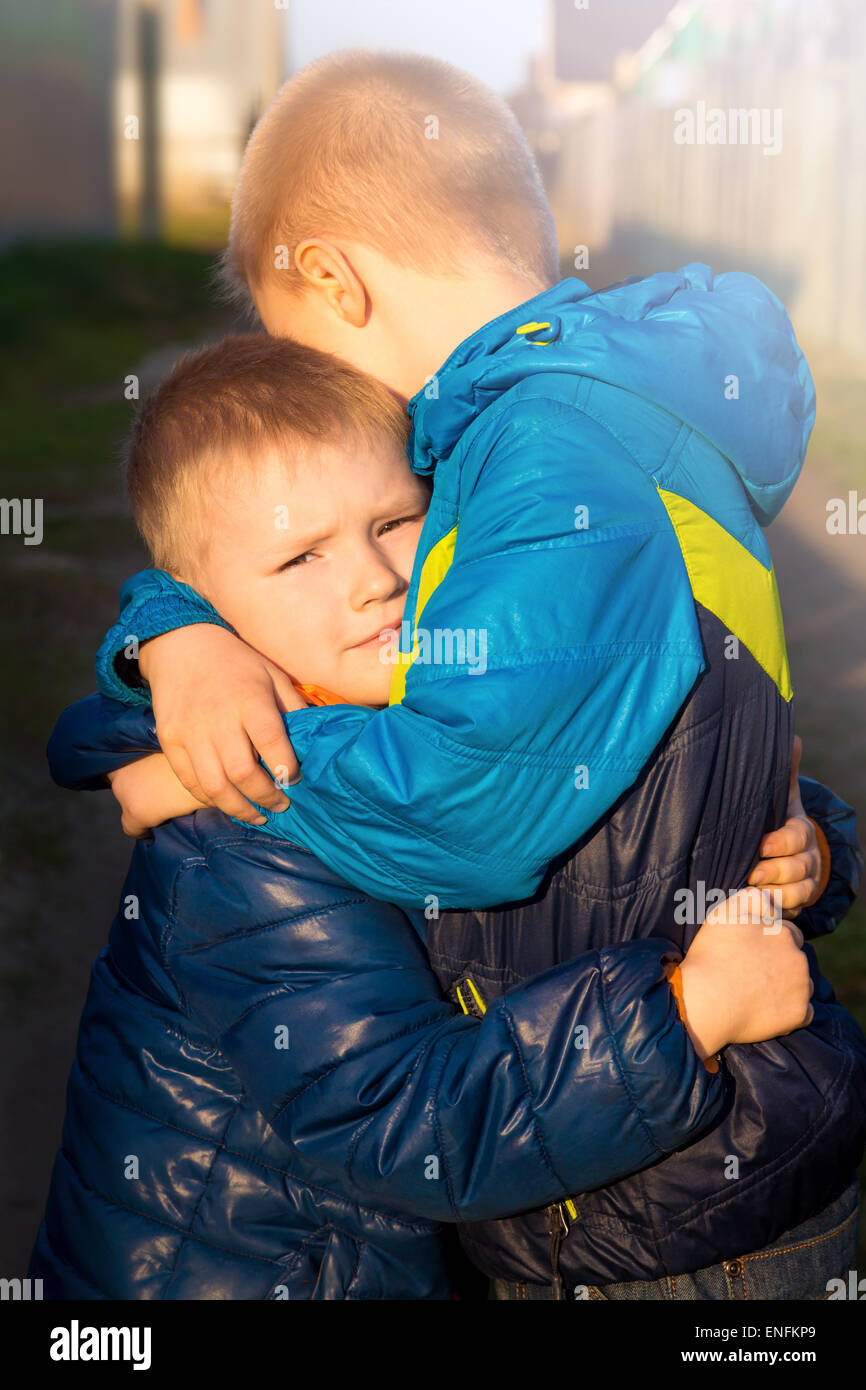 Two little brothers (boys,friends) playing, hugging, having fun outdoor ...