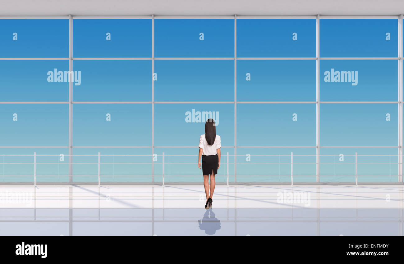 Young businesslady standing back Stock Photo - Alamy