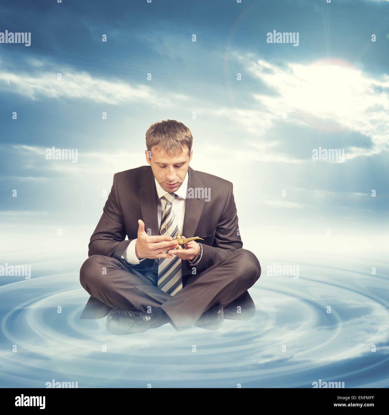 Businessman in suit sitting lotus position Stock Photo - Alamy