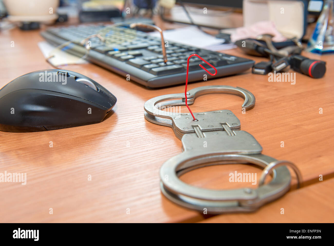 Handcuffs open paper clip on the table office worker Stock Photo - Alamy