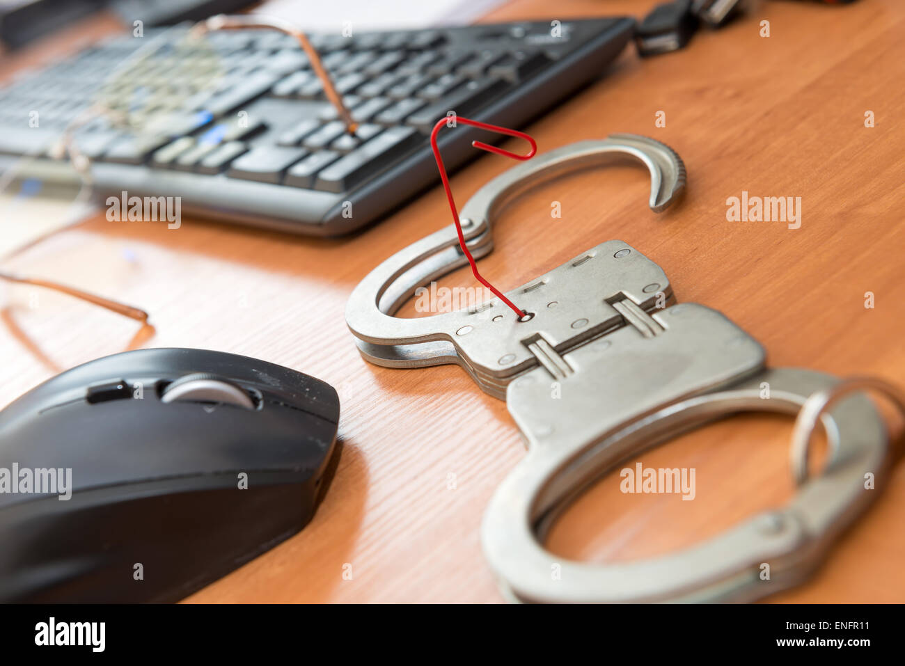 Handcuffs open paper clip on the table office worker Stock Photo - Alamy