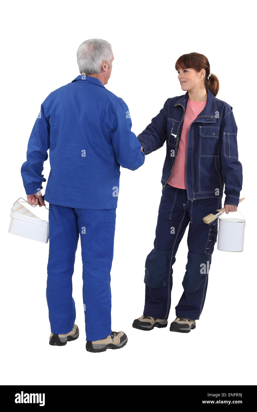 Two painters shaking hands Stock Photo - Alamy