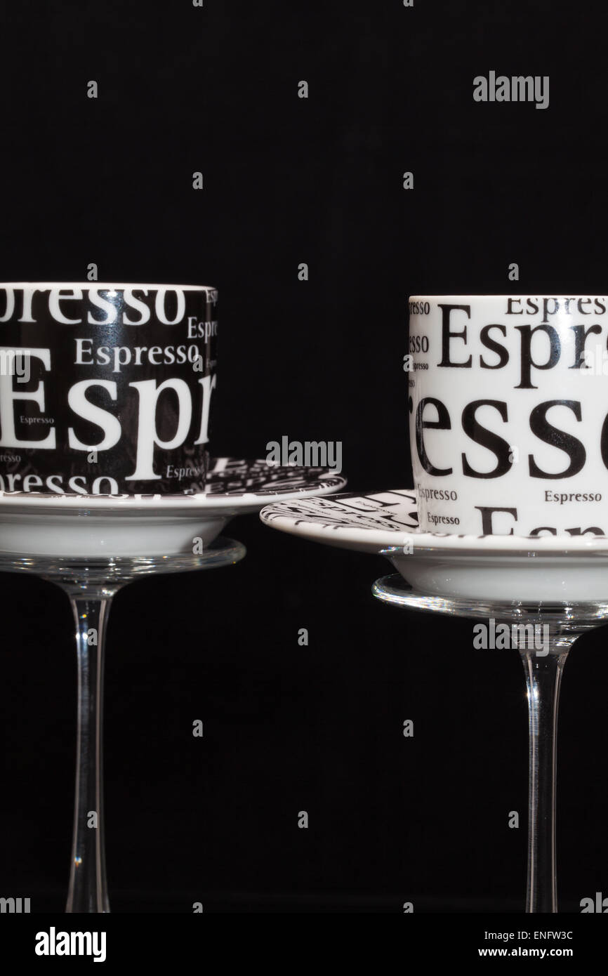 Two empty coffee cups on the black background Stock Photo - Alamy