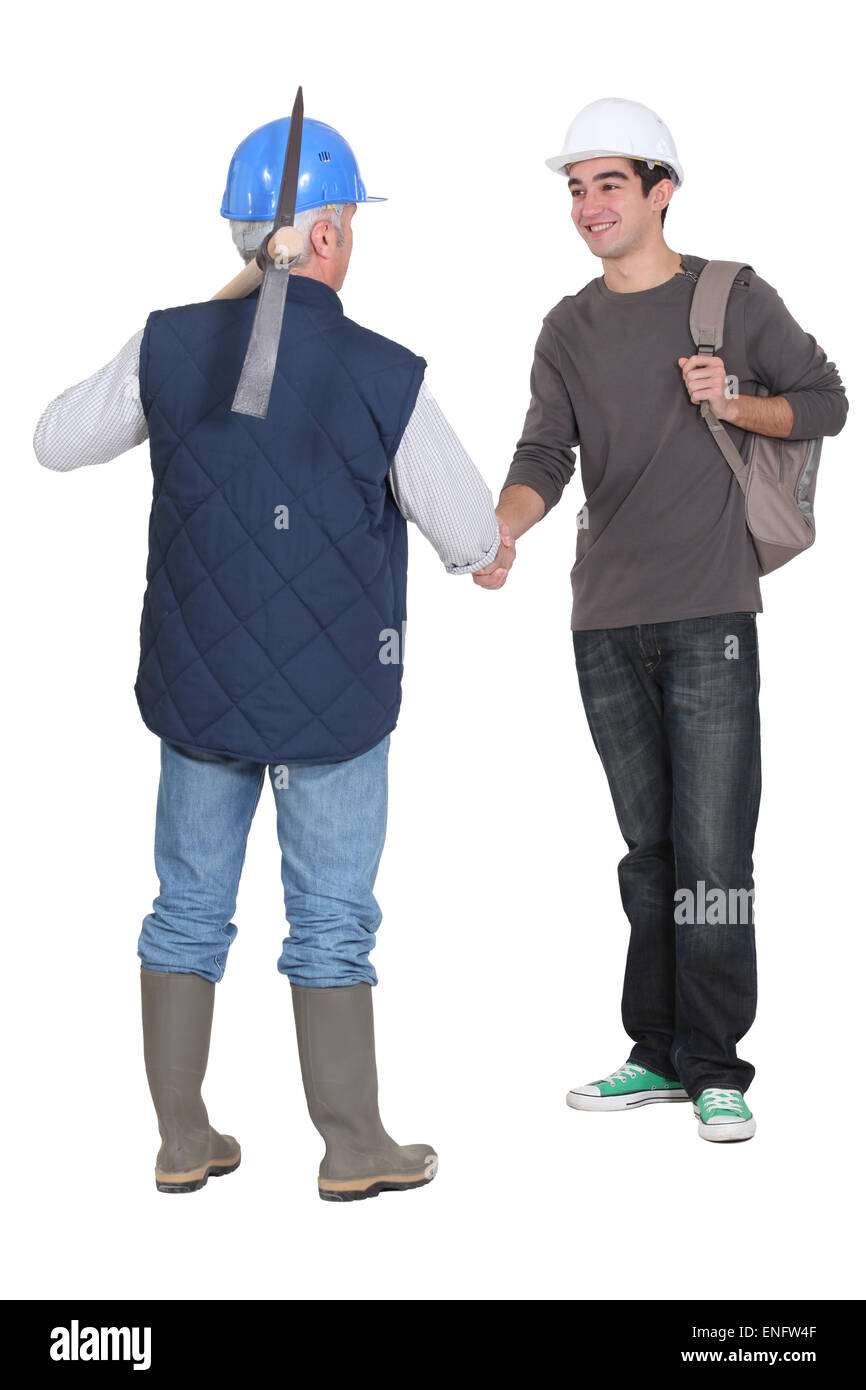 Manual workers shaking hands Stock Photo - Alamy