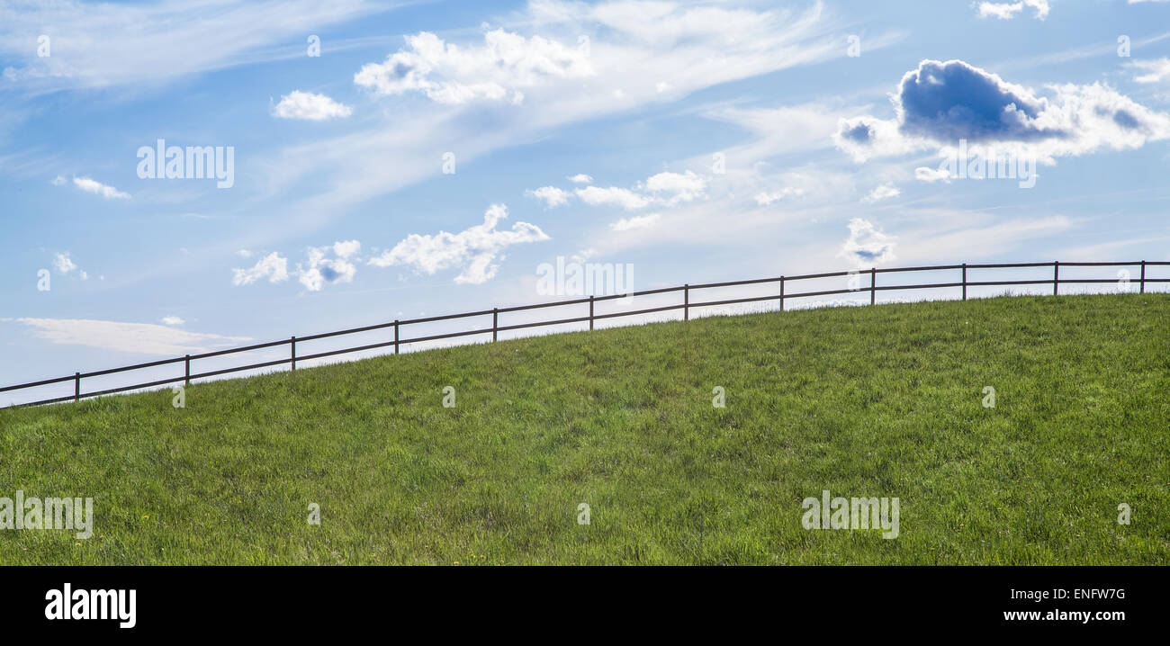 A fence running along a hill climb. As a way parts of the land from the ...
