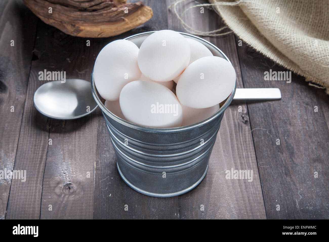 Eggs in a bucket on a black wooden table Stock Photo - Alamy