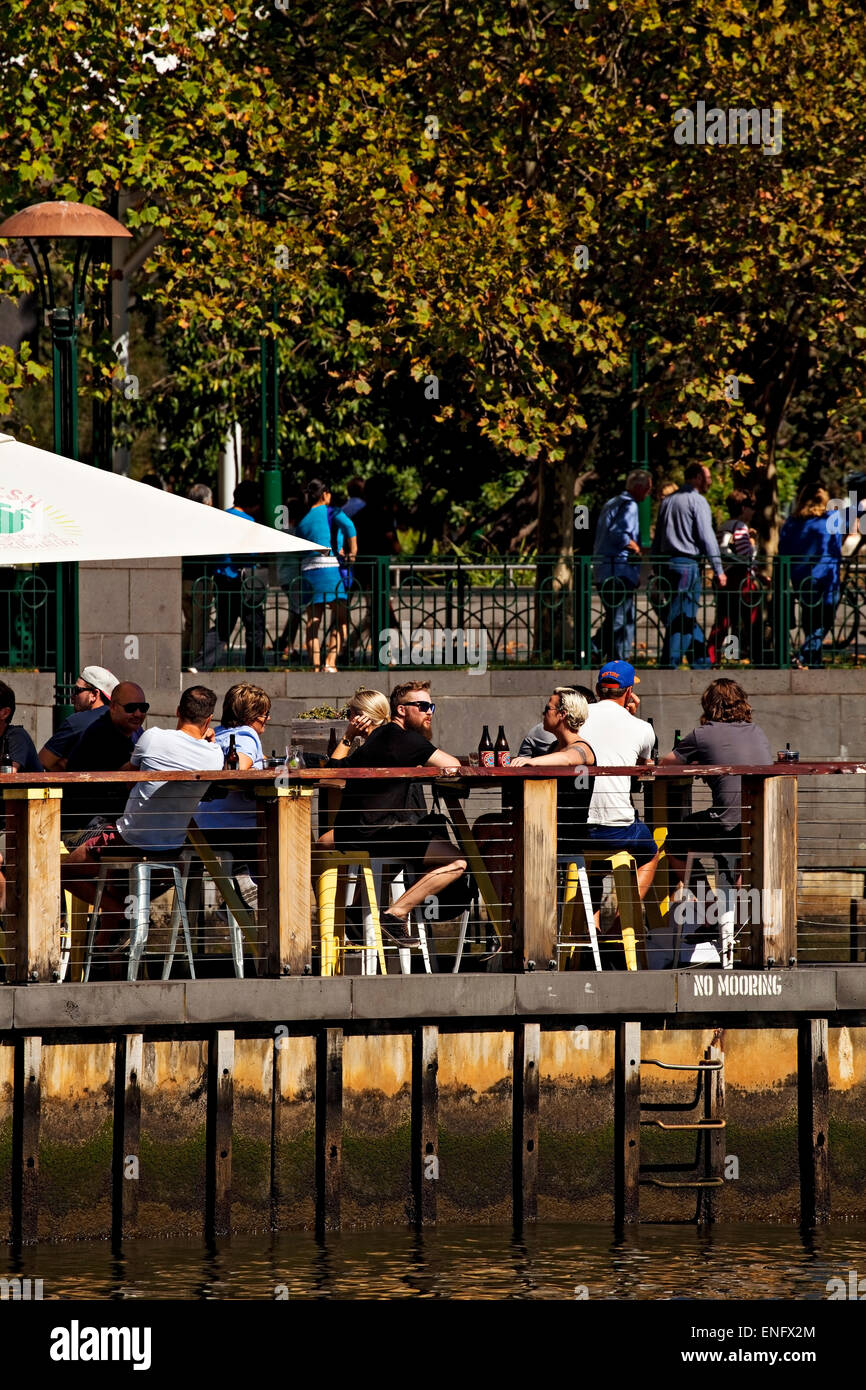Diners enjoy eating beneath the Rainbow Pedestrian Bridge that spans ...