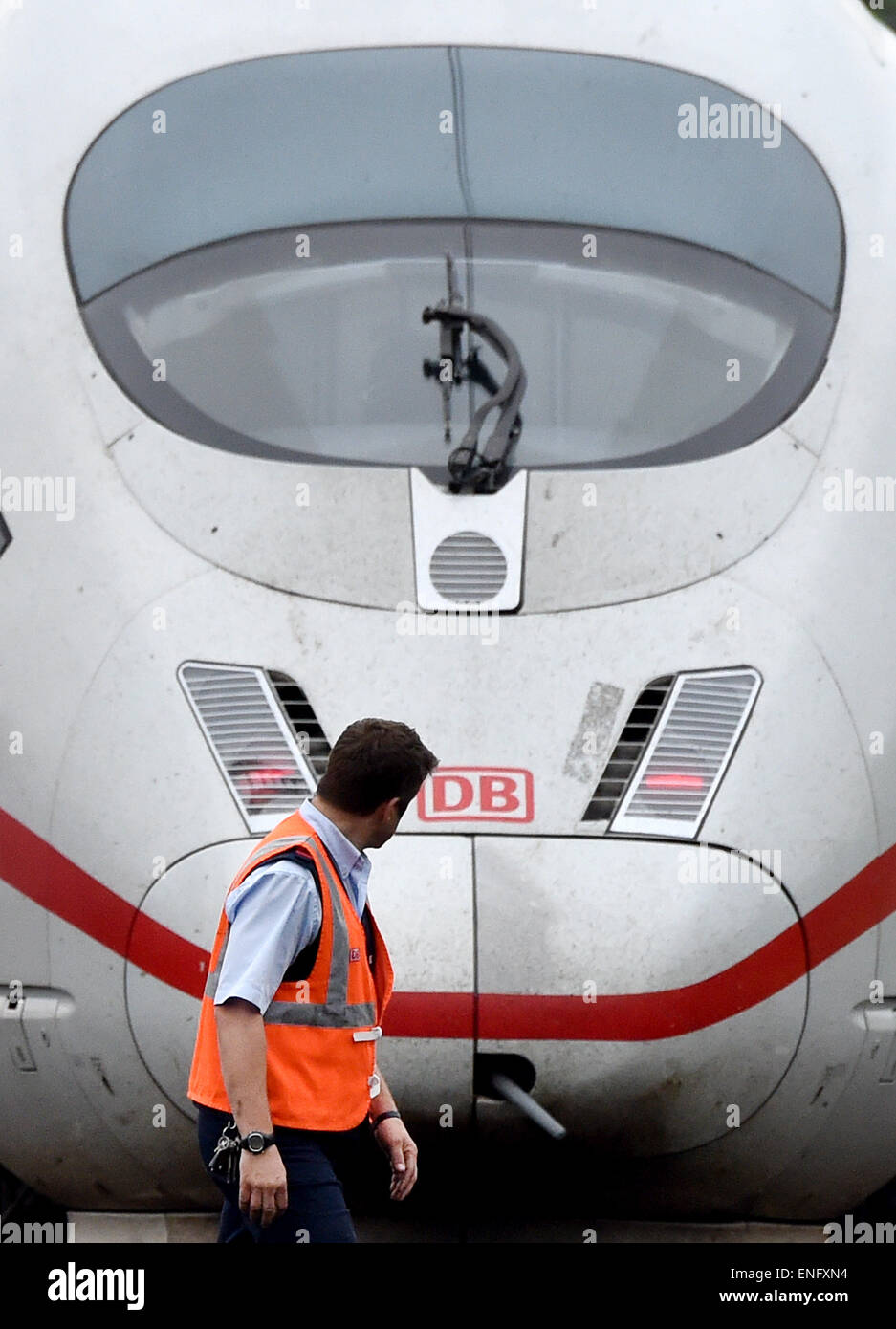 A train driver walks past an ICE high-speed train at the main train ...