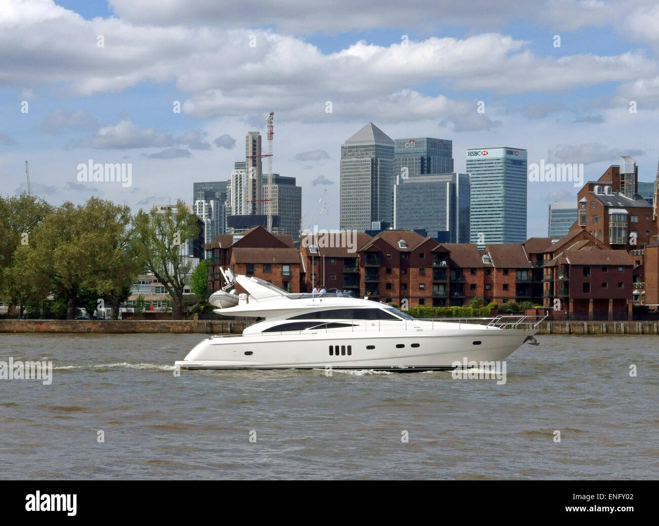 Luxury yacht on River Thames against Canary Wharf skyline, London Stock ...