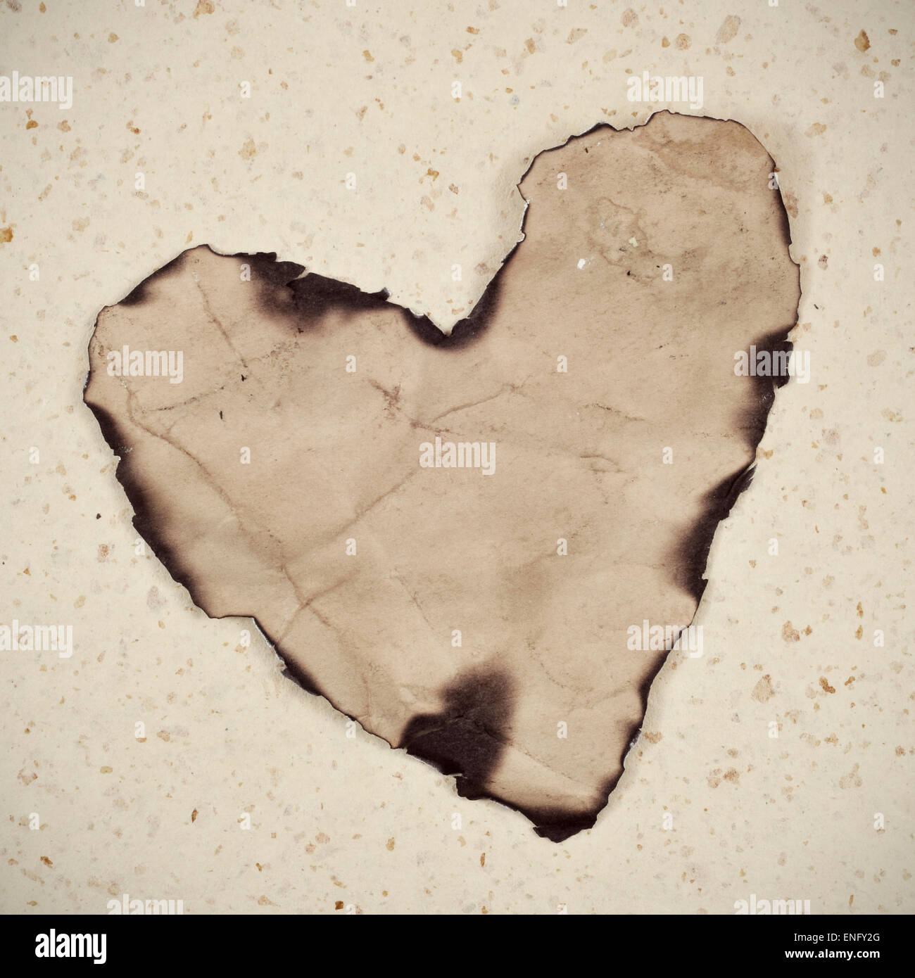old paper heart with burnt edges on a textured background Stock Photo ...