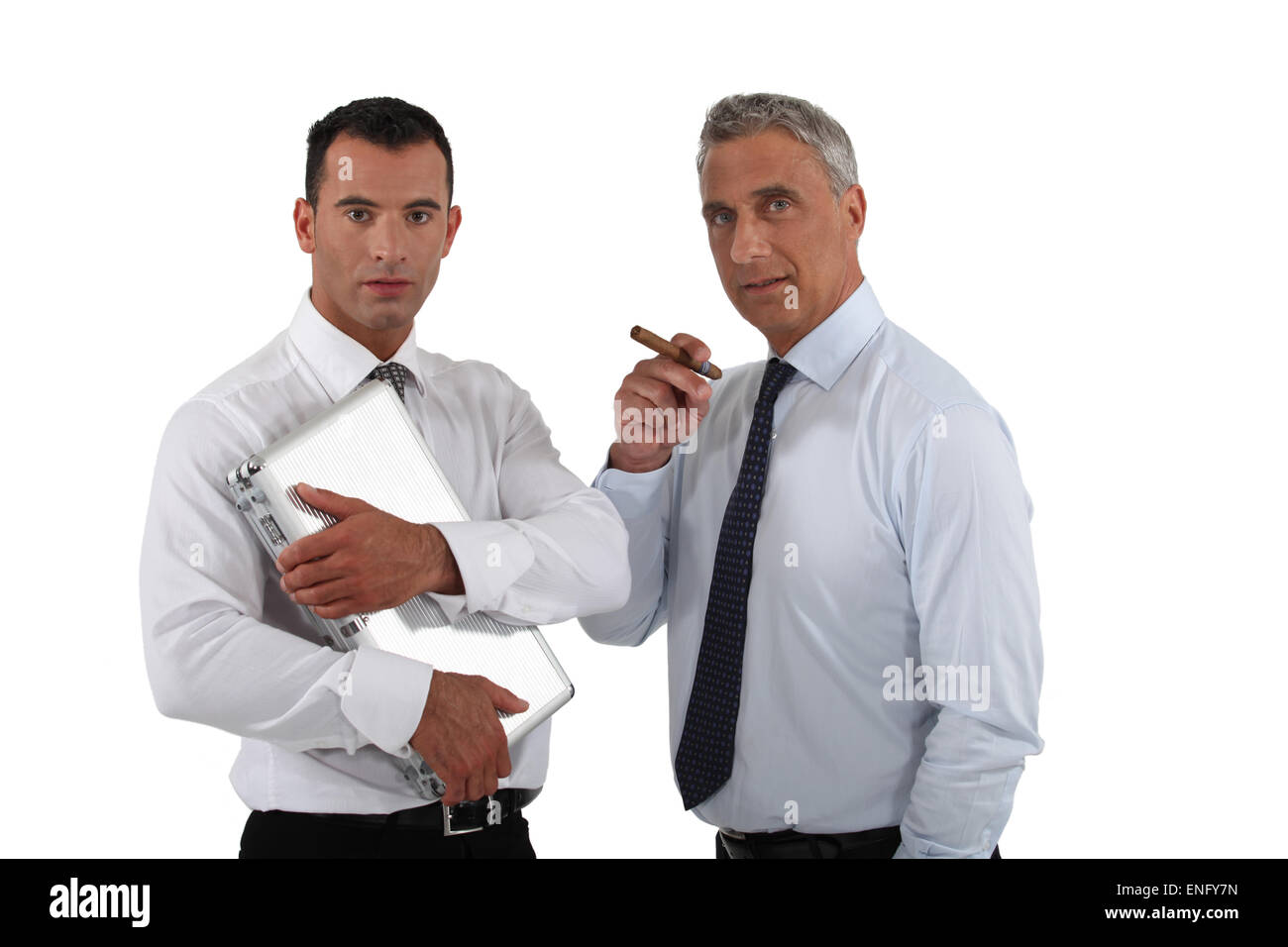 Boss holding cigar whilst employee does all the work Stock Photo - Alamy