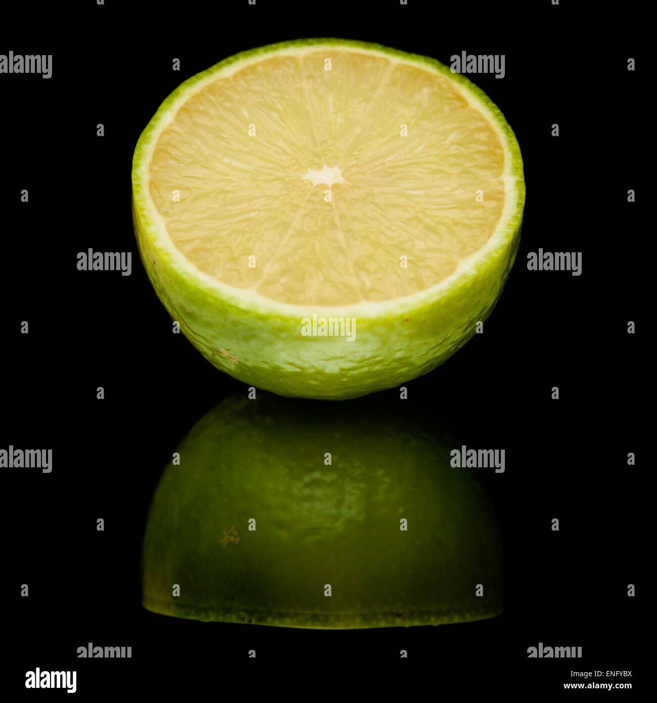 lime fruit on black mirror, isolated Stock Photo - Alamy