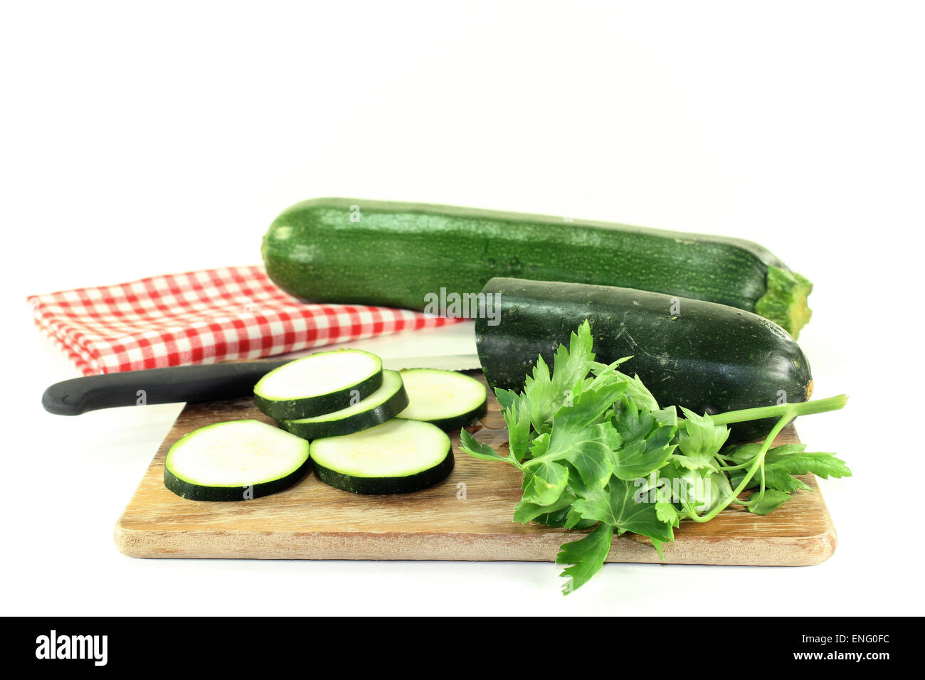 green, raw zucchini in front of white background Stock Photo - Alamy