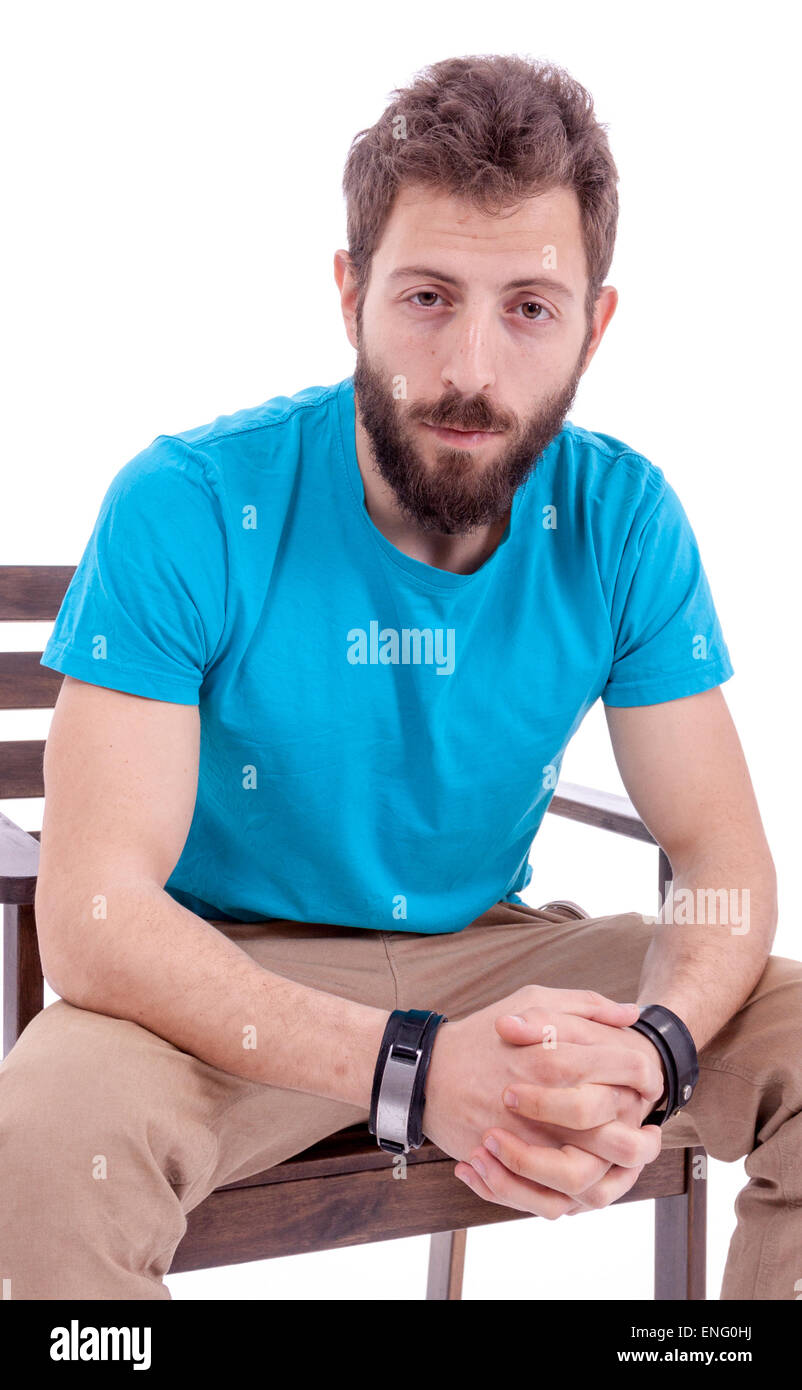 Smiling young man with beard posing with a blue shirt Stock Photo - Alamy
