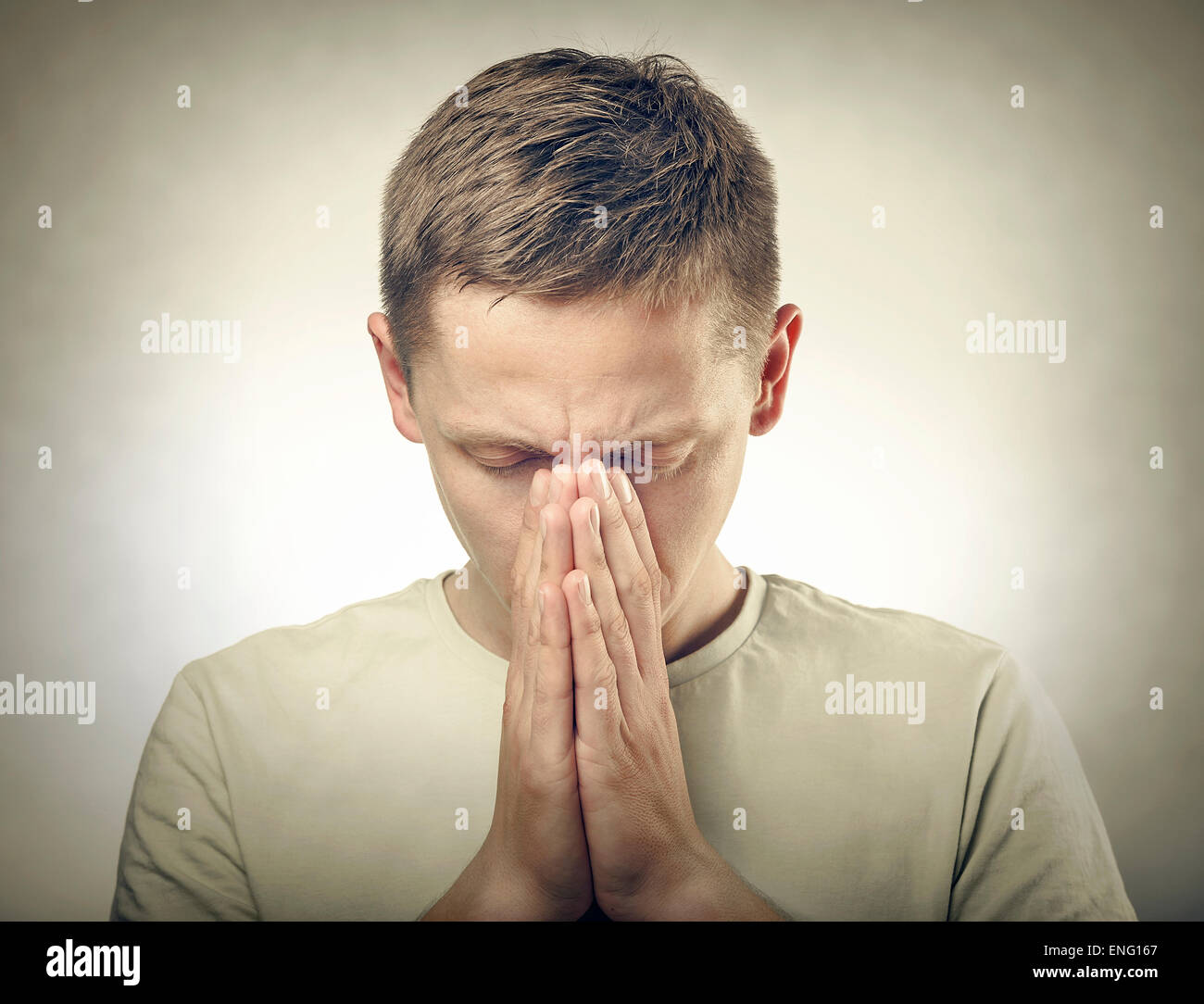 Young man praying Stock Photo - Alamy