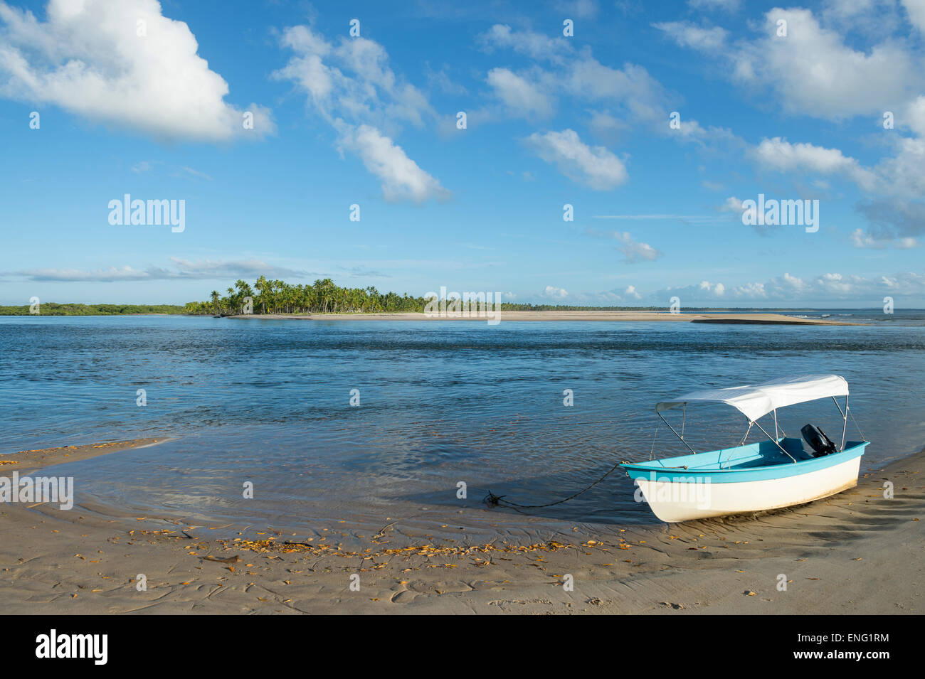 Brazilian boat landed on the shore of a rustic beach on a remote island ...