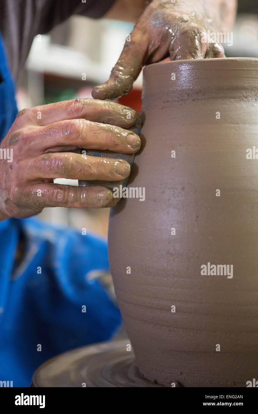 Older Caucasian man forming pottery on wheel in ceramics studio Stock ...