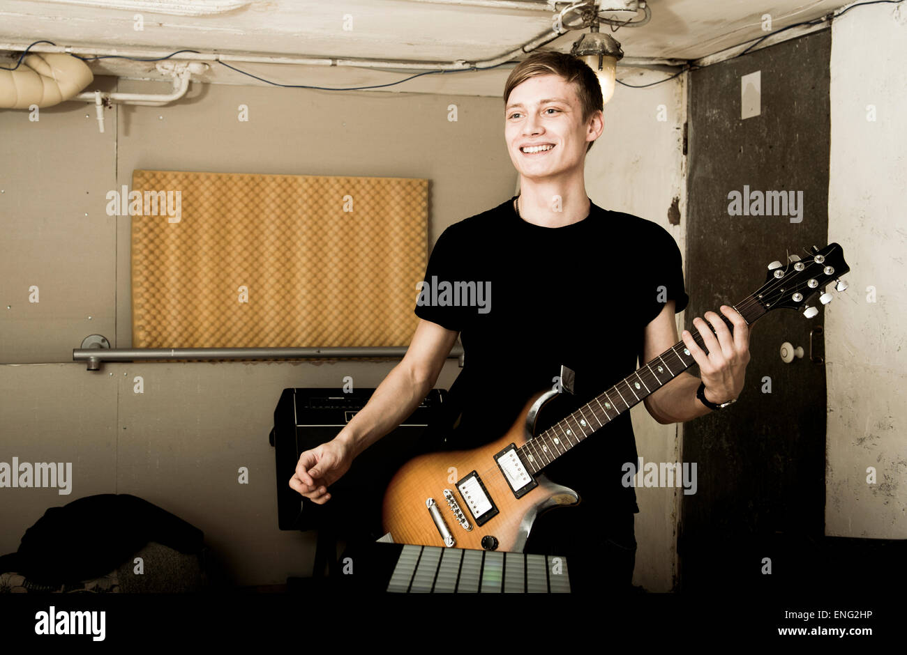 Caucasian man playing electric guitar in rock band Stock Photo - Alamy